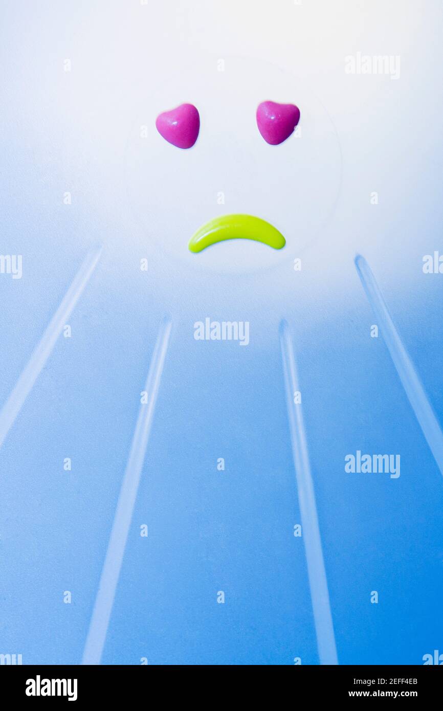 Candy depicting an unhappy face Stock Photo - Alamy