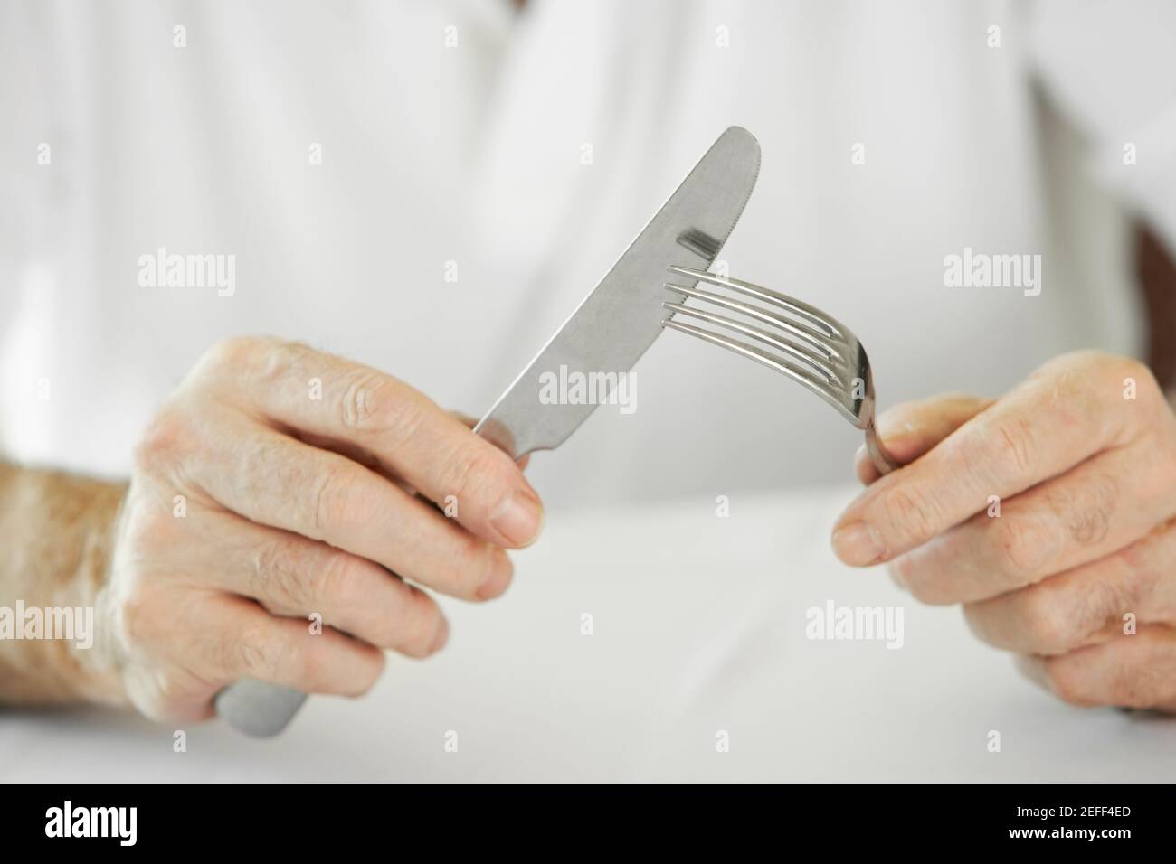 Human hand holding knife fork hi-res stock photography and images - Alamy
