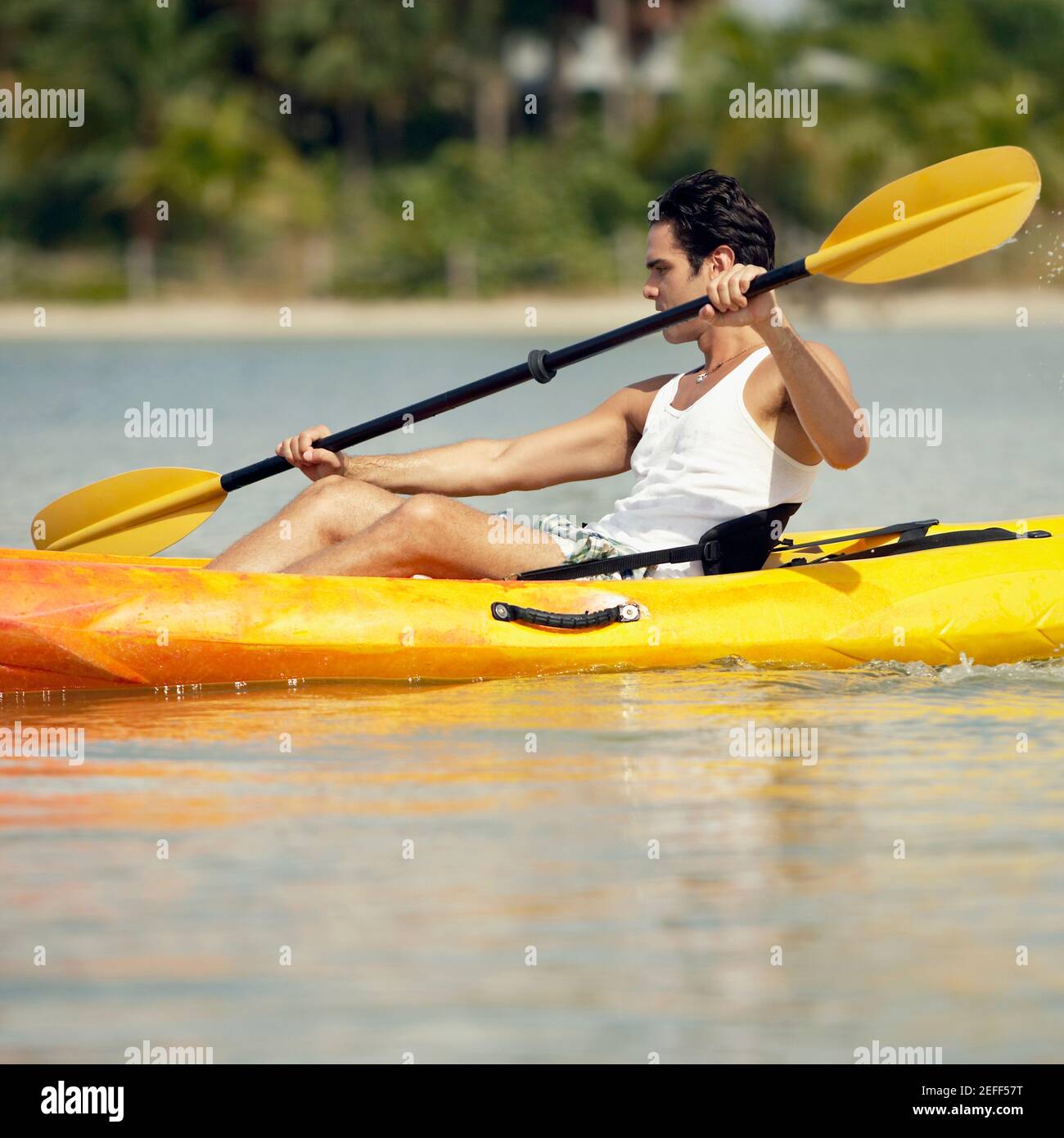 Side profile of a young man kayaking Stock Photo - Alamy