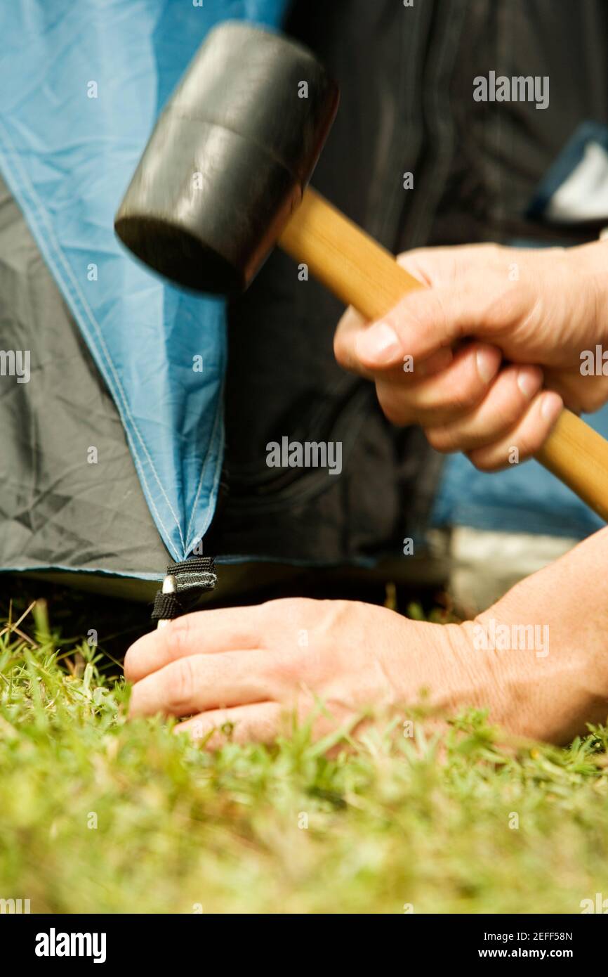 Putting up tent with mallet hi-res stock photography and images - Alamy