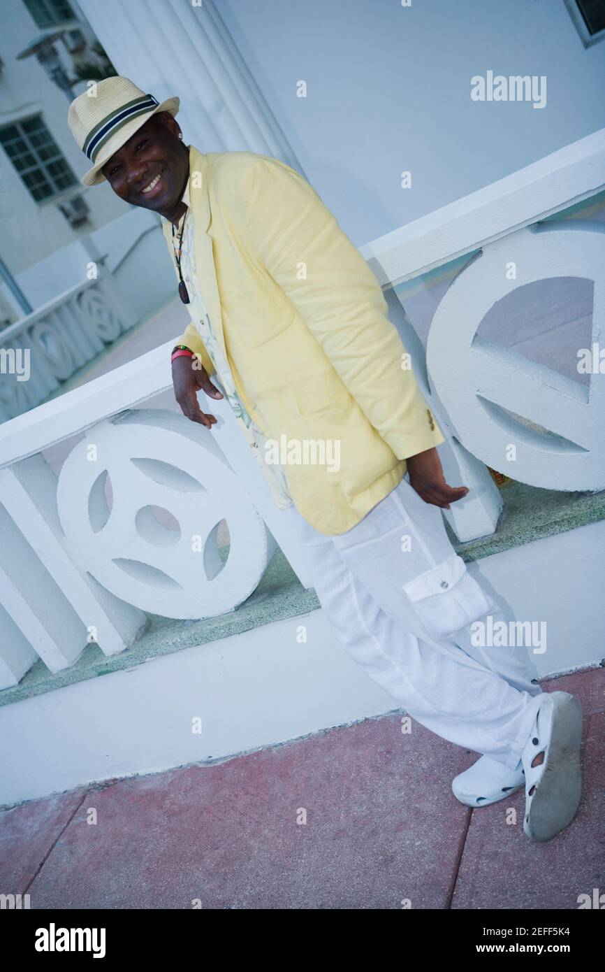 Portrait of a mature man leaning against a balustrade Stock Photo - Alamy