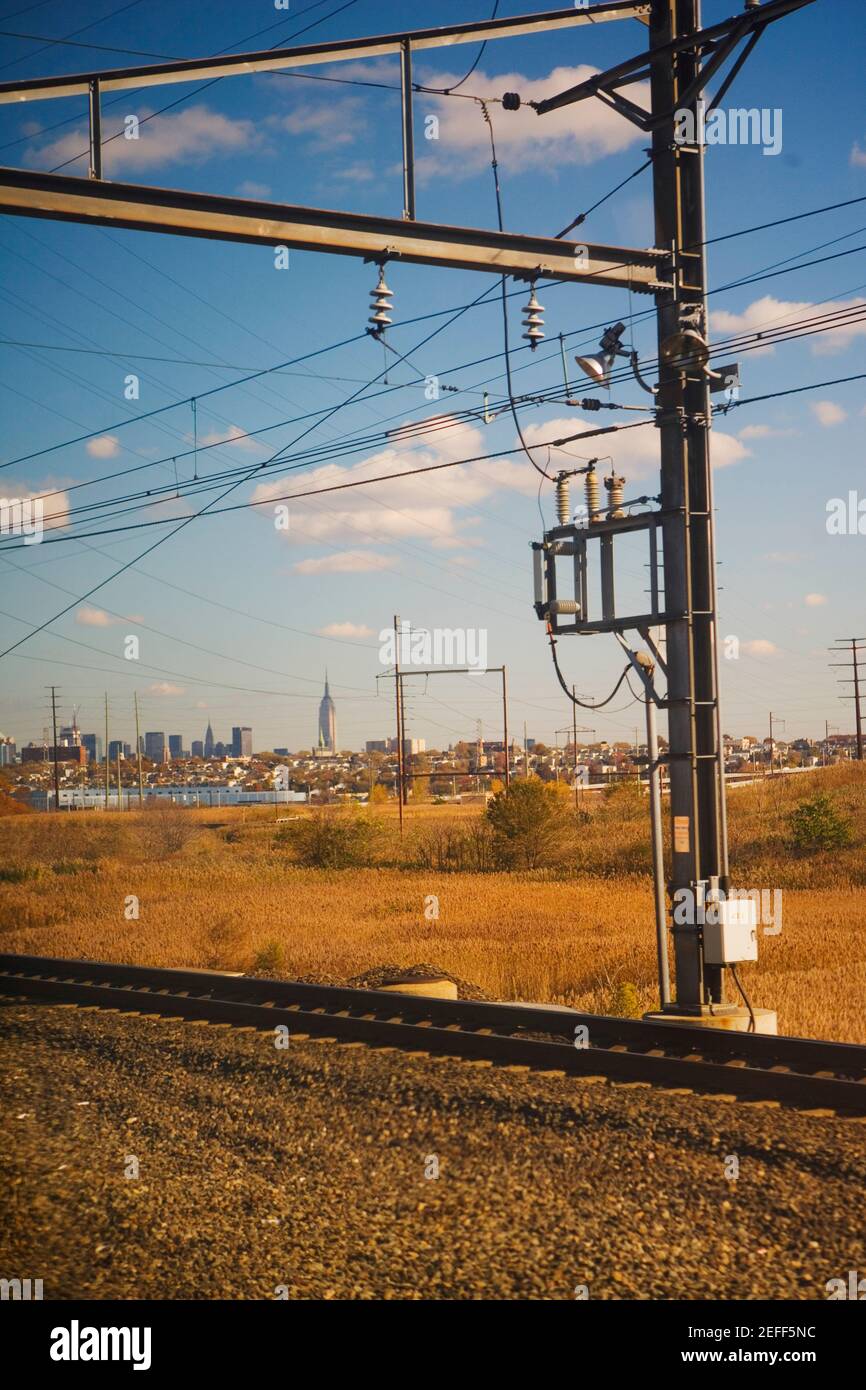 Electricity pylon at a railroad track Stock Photo - Alamy