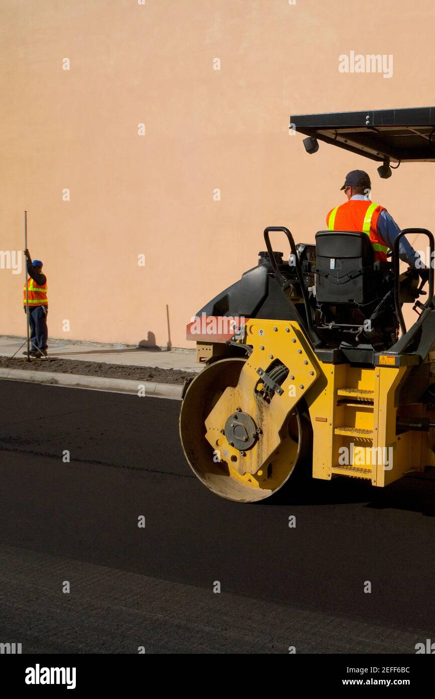 Rear view of a man driving a steamroller Stock Photo - Alamy