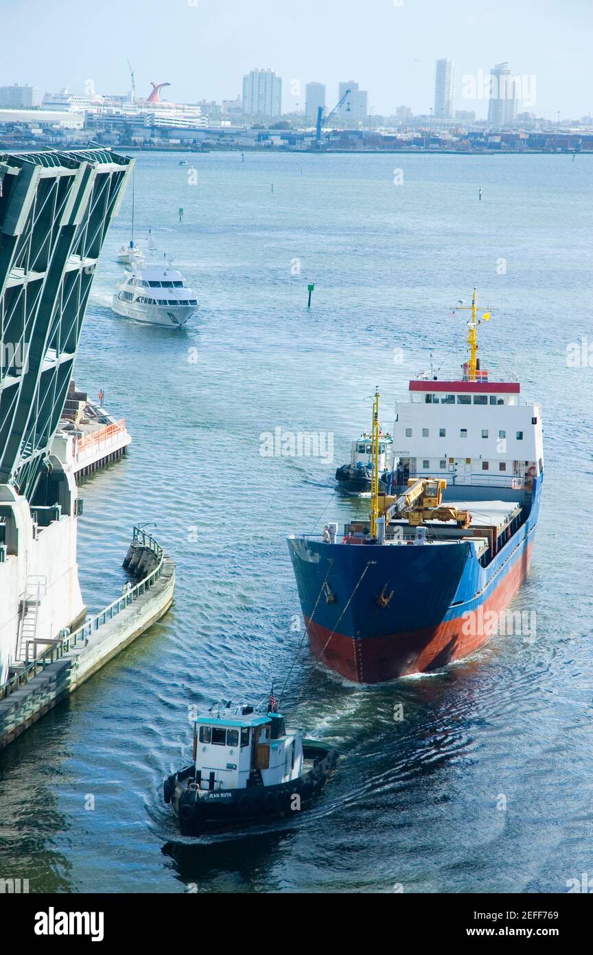 High angle view of a tugboat pulling a cargo container Stock Photo - Alamy