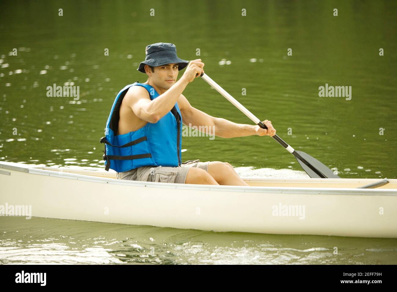 Portrait of a mid adult man boating in a river Stock Photo - Alamy