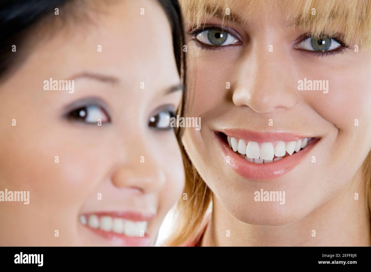 Portrait of two young women smiling Stock Photo - Alamy