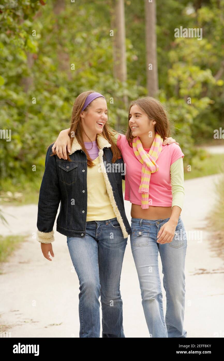 Two girls with their arms around each other Stock Photo - Alamy