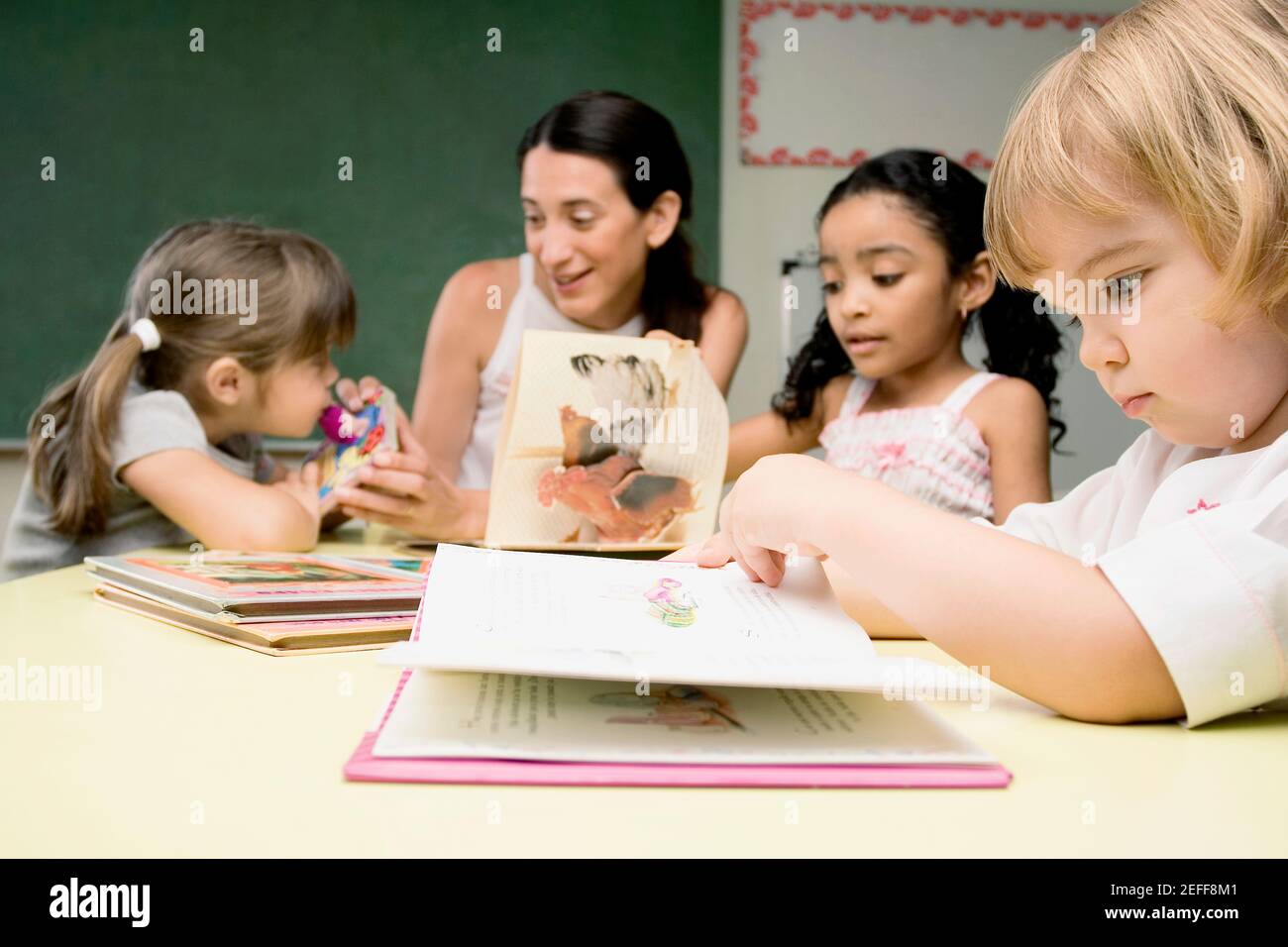 Female teacher teaching her students in a classroom Stock Photo - Alamy