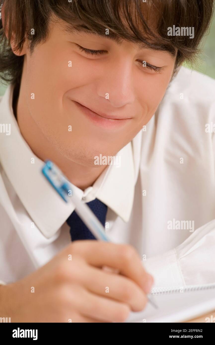 Close up of a high school student writing in a notebook Stock Photo - Alamy