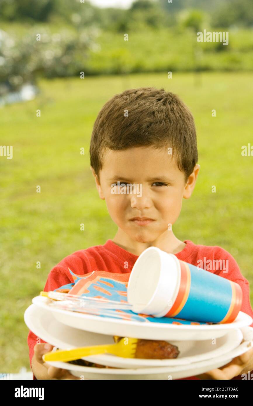 Portrait of a boy holding plates Stock Photo - Alamy