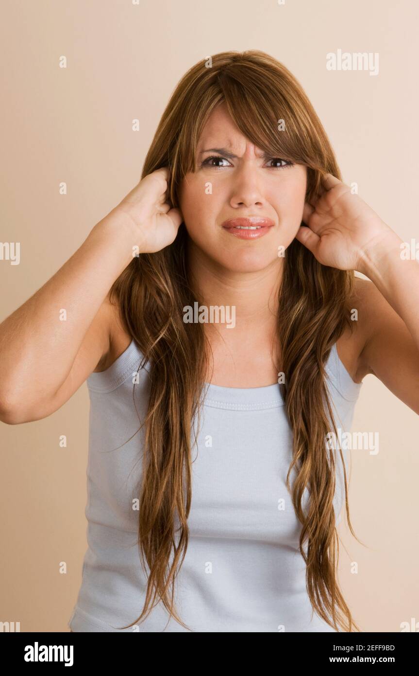 Close up woman covering ears hi-res stock photography and images - Alamy
