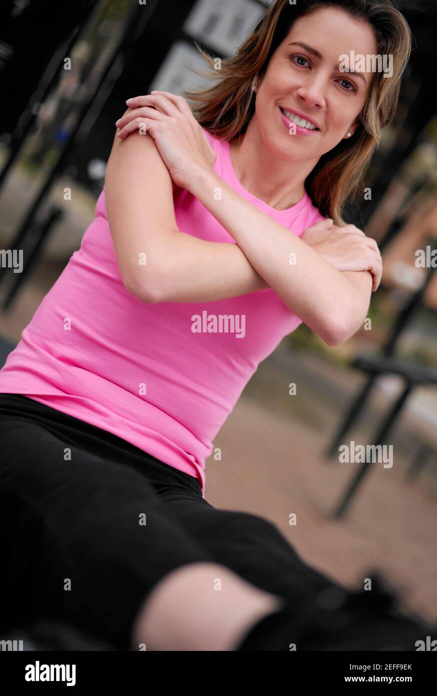 Portrait of a young woman doing sit-ups with her arms crossed Stock ...