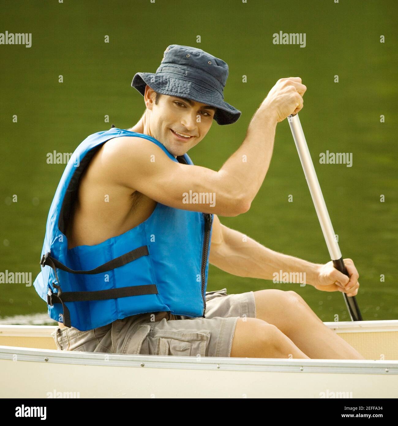 Portrait of a mid adult man boating in a river Stock Photo - Alamy