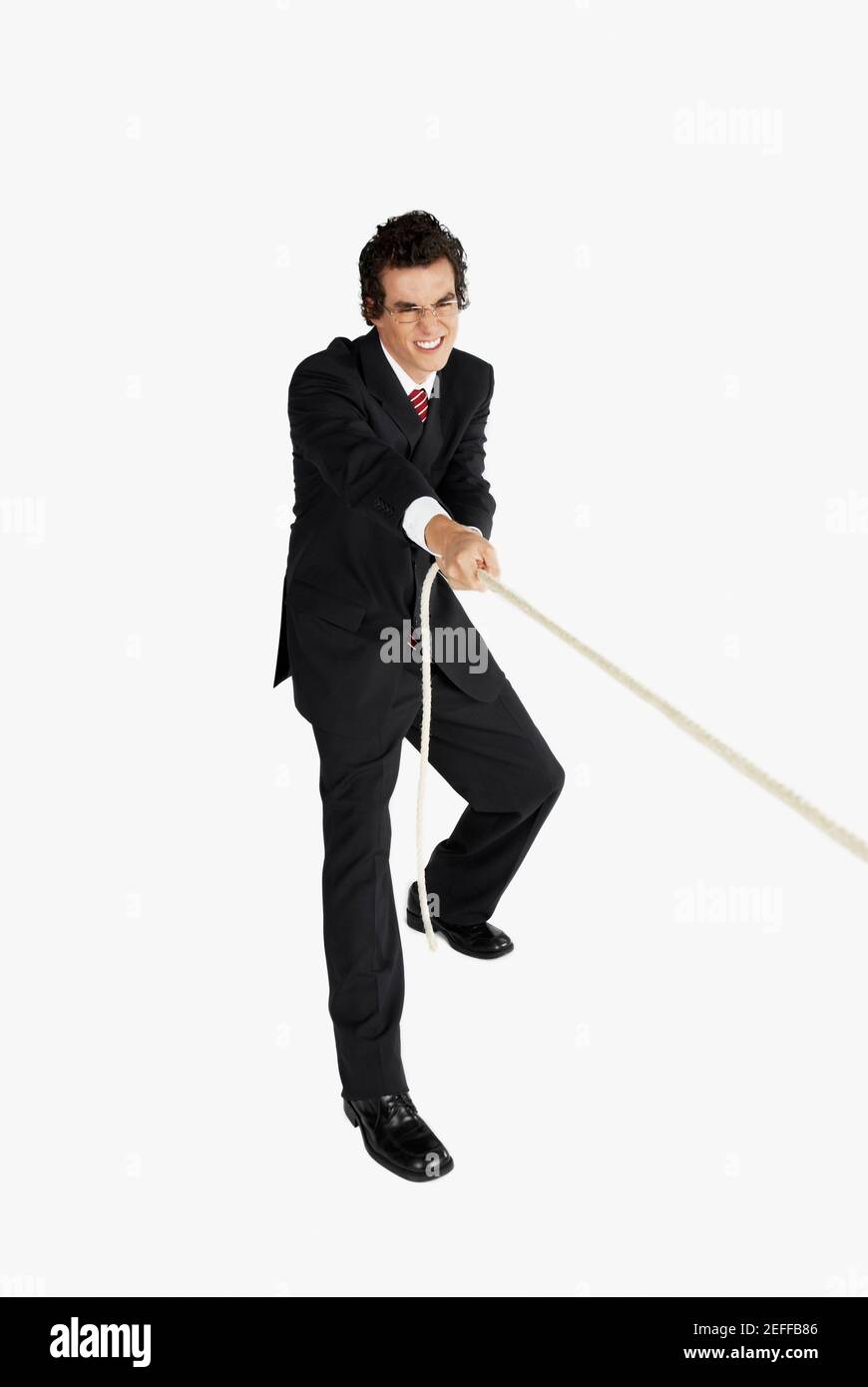 Businessman pulling a rope Stock Photo - Alamy
