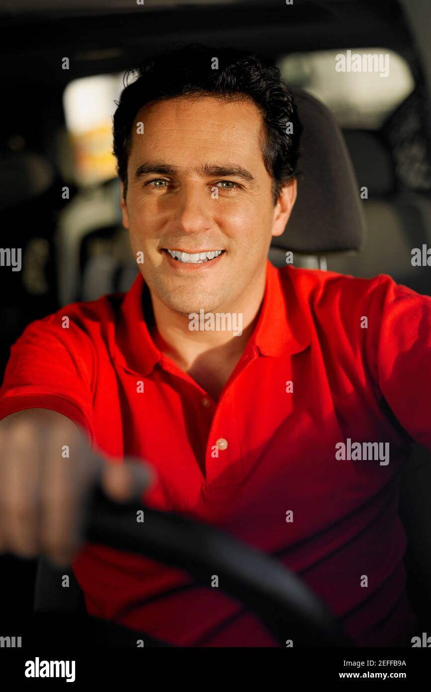 Hispanic man steering vehicle hi-res stock photography and images - Alamy