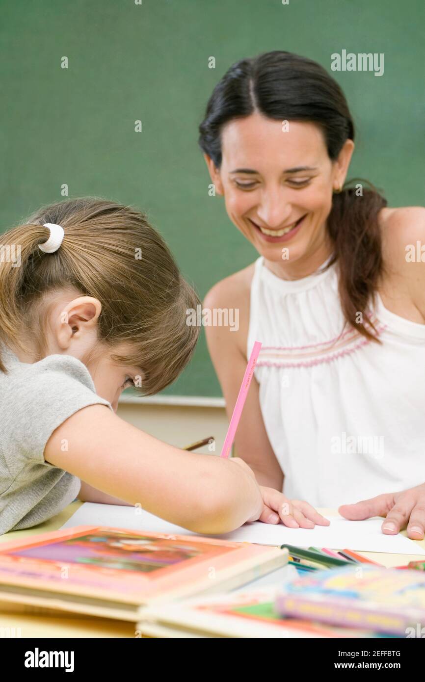 Female teacher teaching her student in a classroom Stock Photo - Alamy