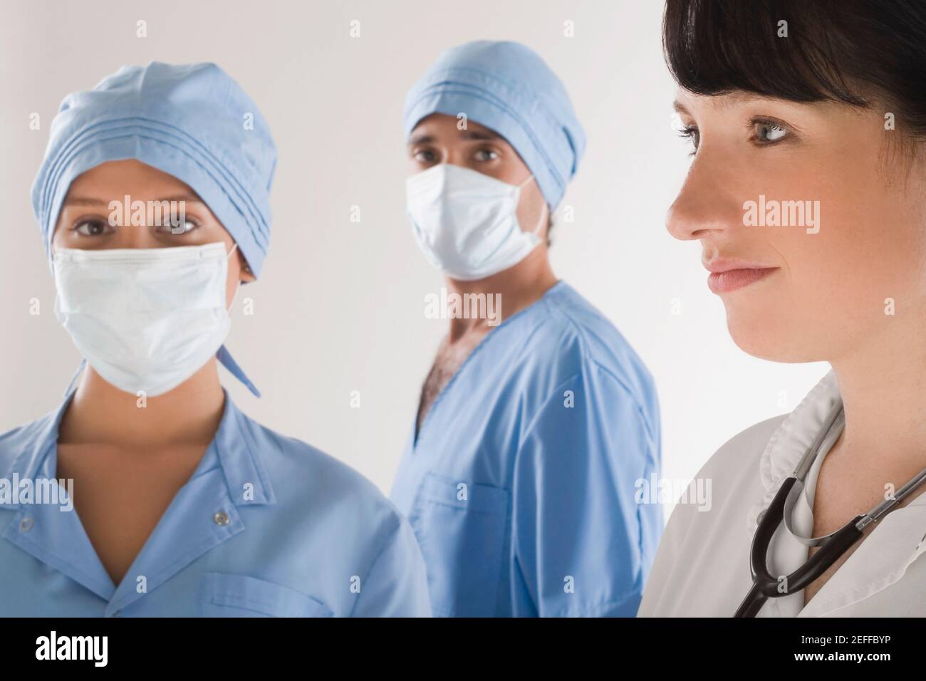 Female doctor with two surgeons Stock Photo - Alamy