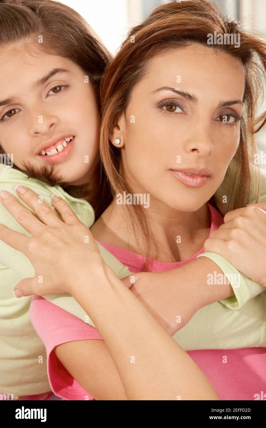 Portrait of a daughter hugging her mother from behind Stock Photo - Alamy