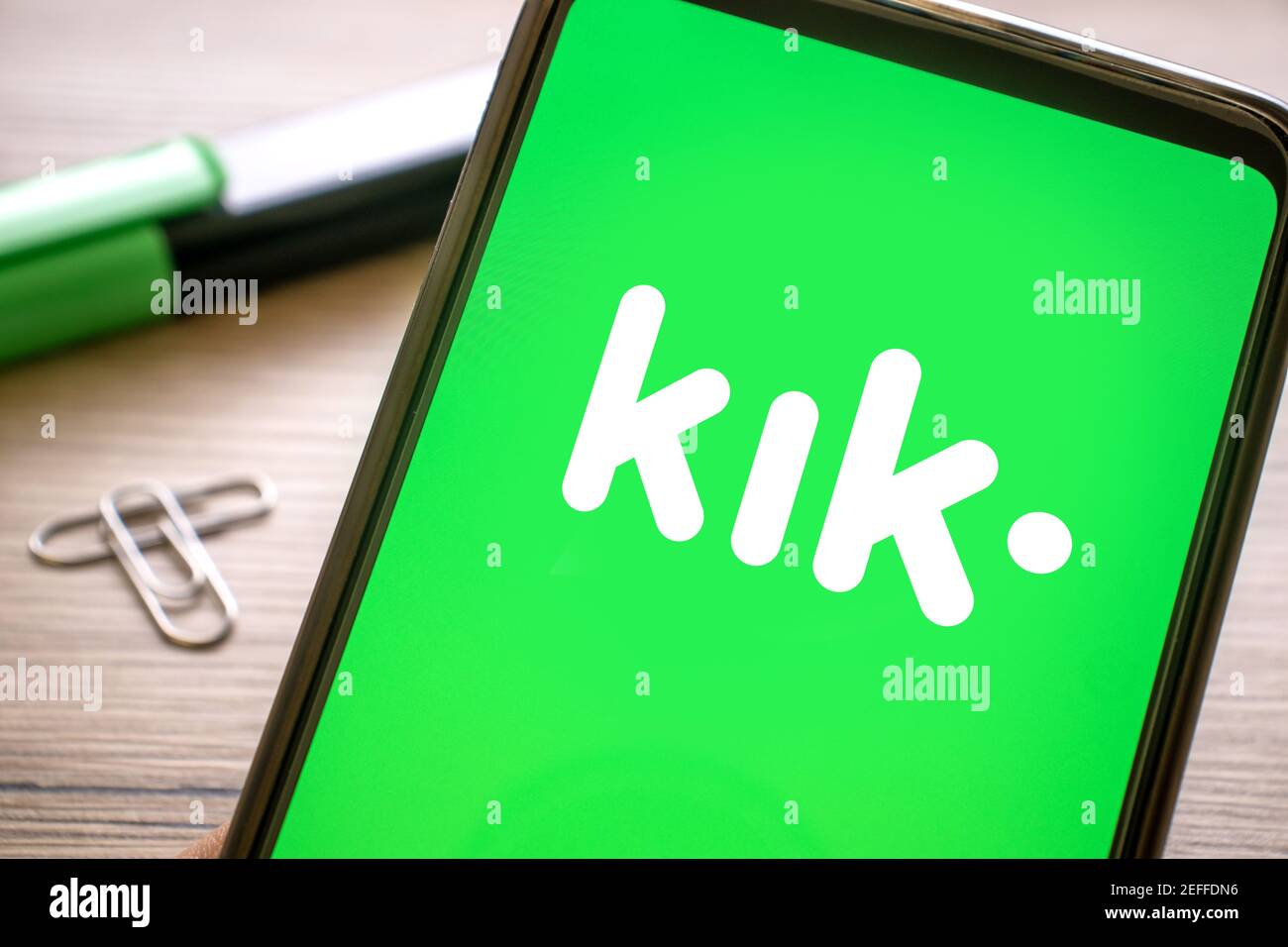 kik logo on the green screen of a smartphone. Messaging app on phone ...