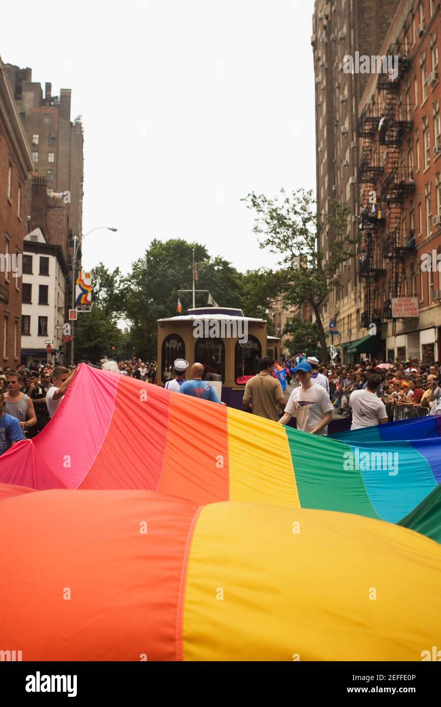 Group of people pulling a giant gay pride flag at a gay parade Stock ...
