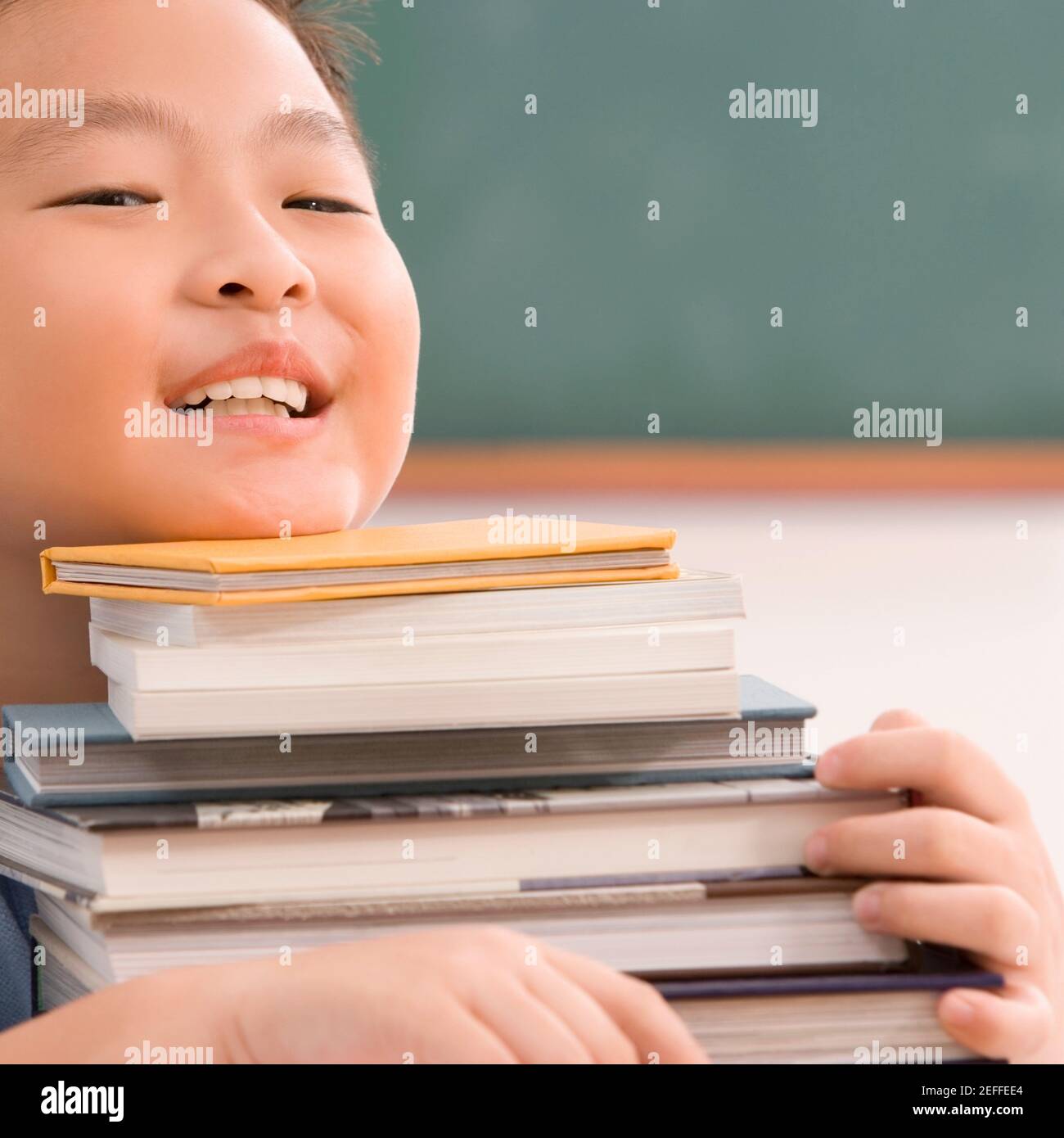 Boy carrying book hi-res stock photography and images - Alamy