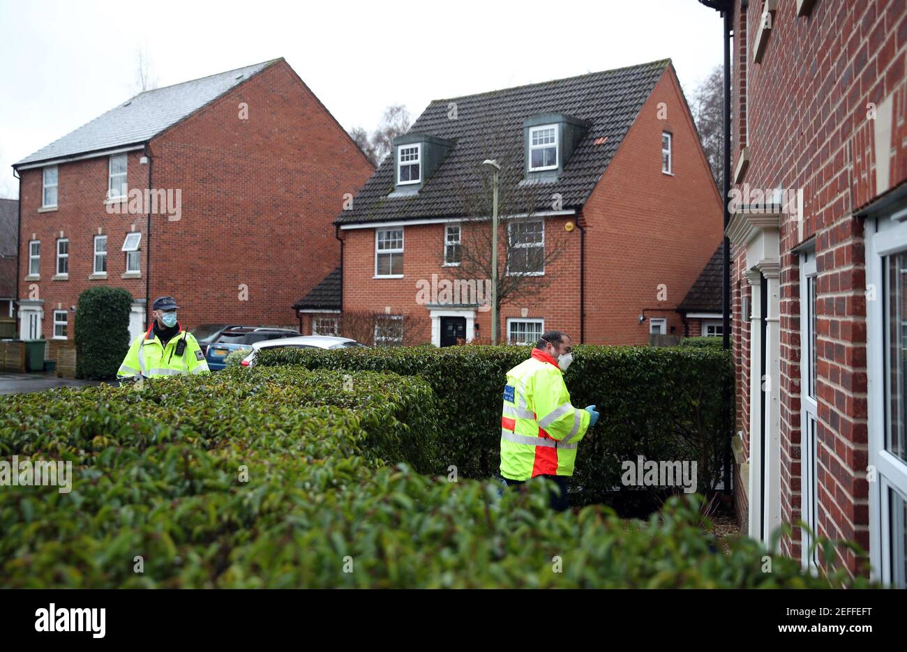 A Community safety patrol officer hands a coronavirus test to a ...