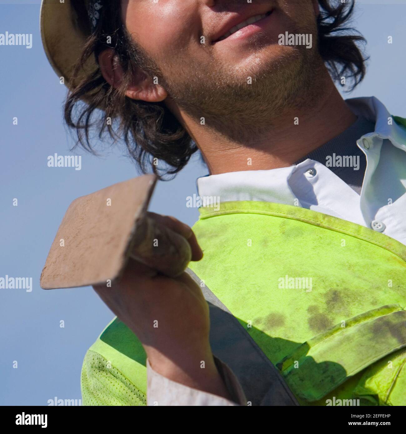 Mid section view of a construction worker holding a hand tool Stock ...