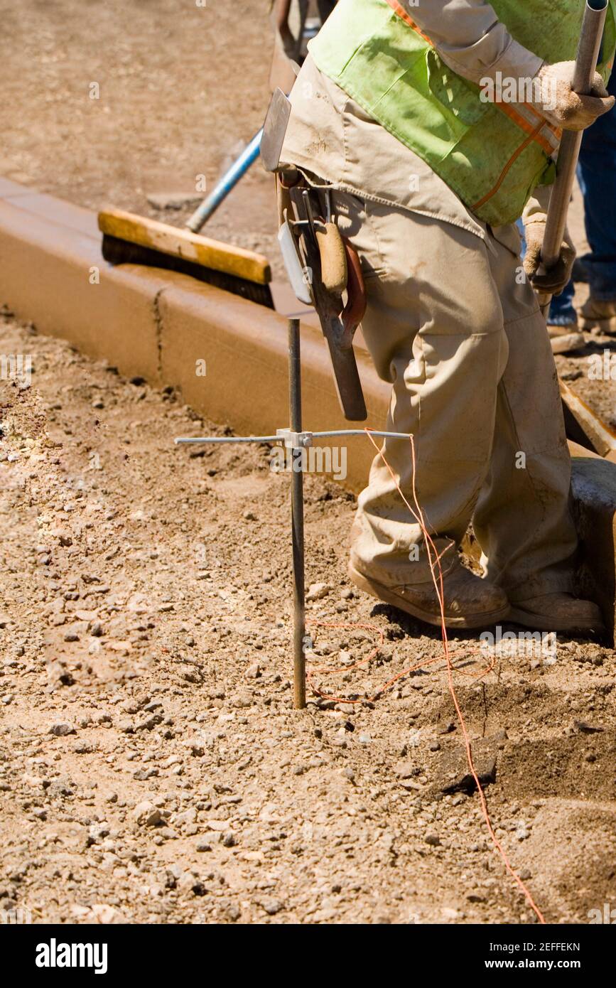 Side profile of construction workers working at a construction site ...