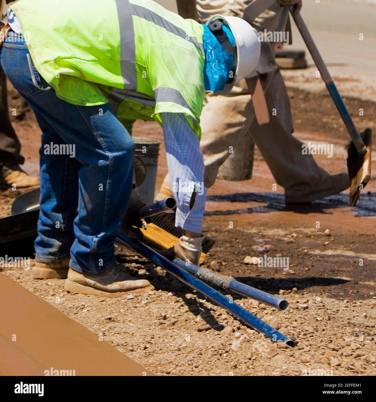 Three construction workers working at a construction site Stock Photo ...