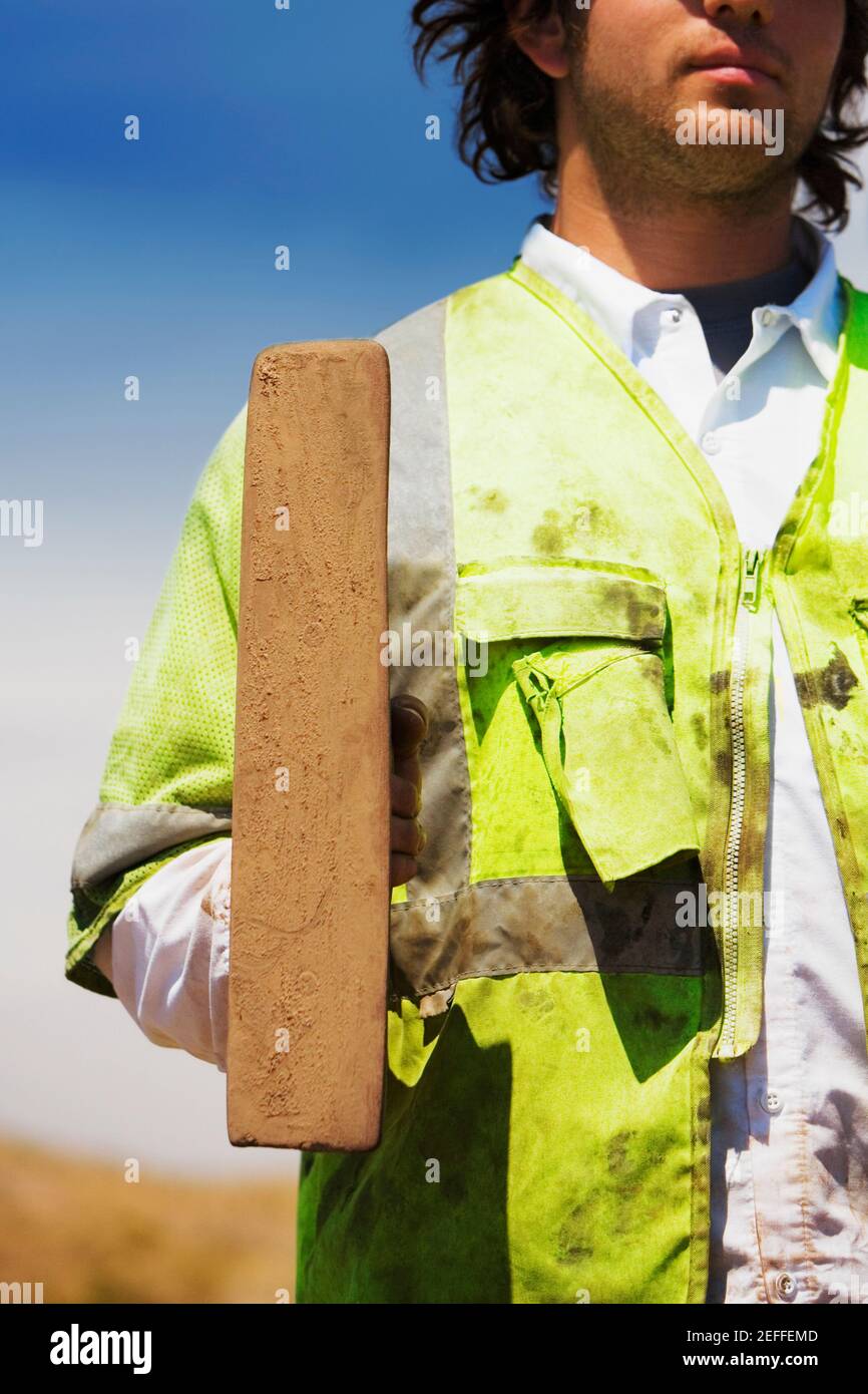Mid section view of a construction worker holding a hand tool Stock ...