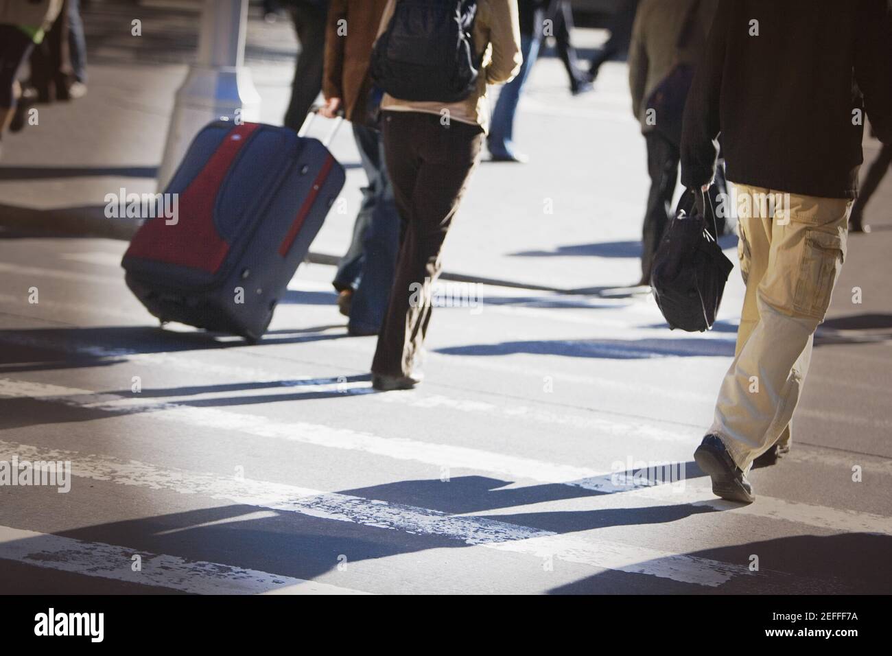 Low section view of men and women walking on the road Stock Photo - Alamy