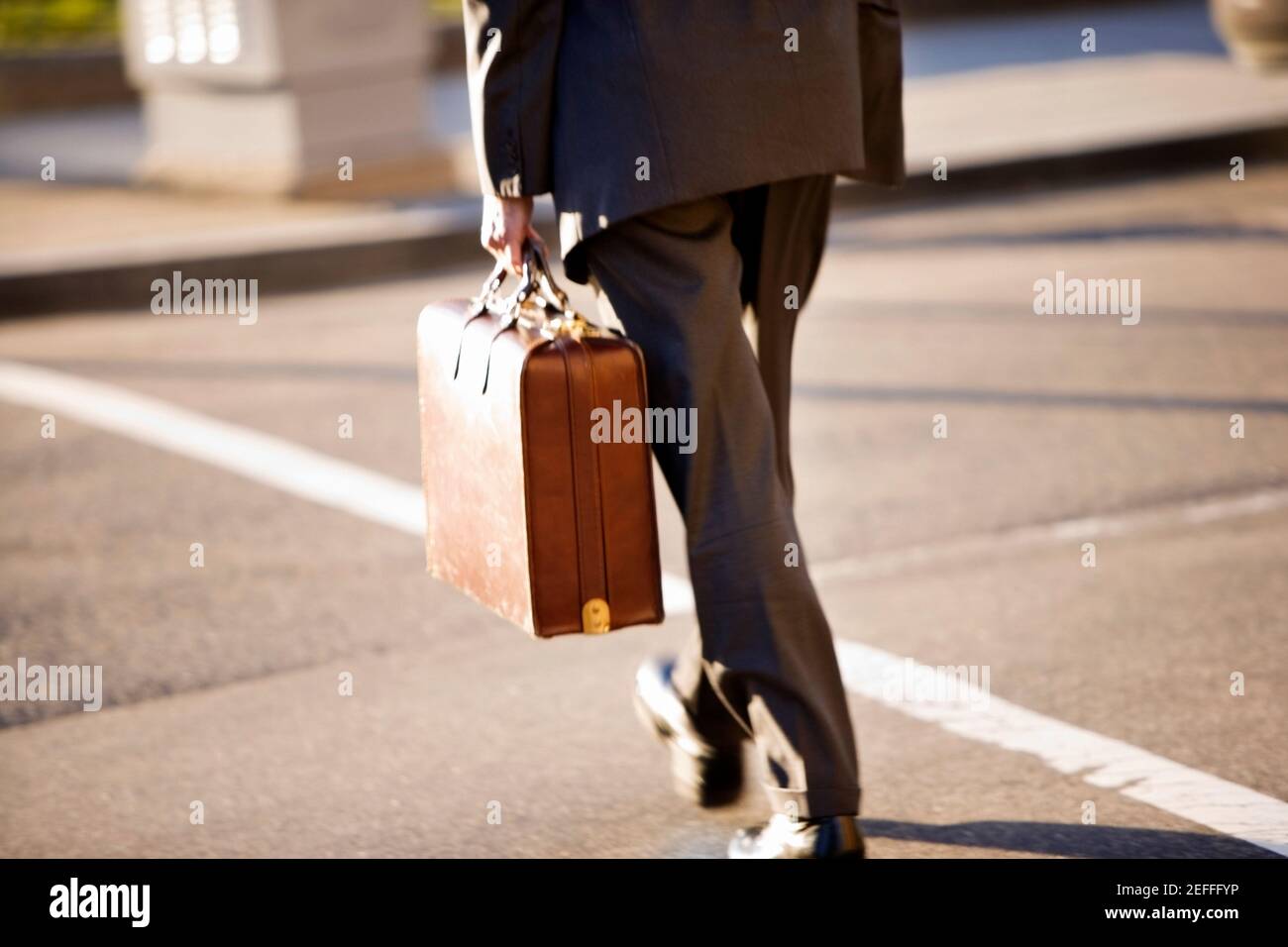 Businessman walking briefcase street hi-res stock photography and ...