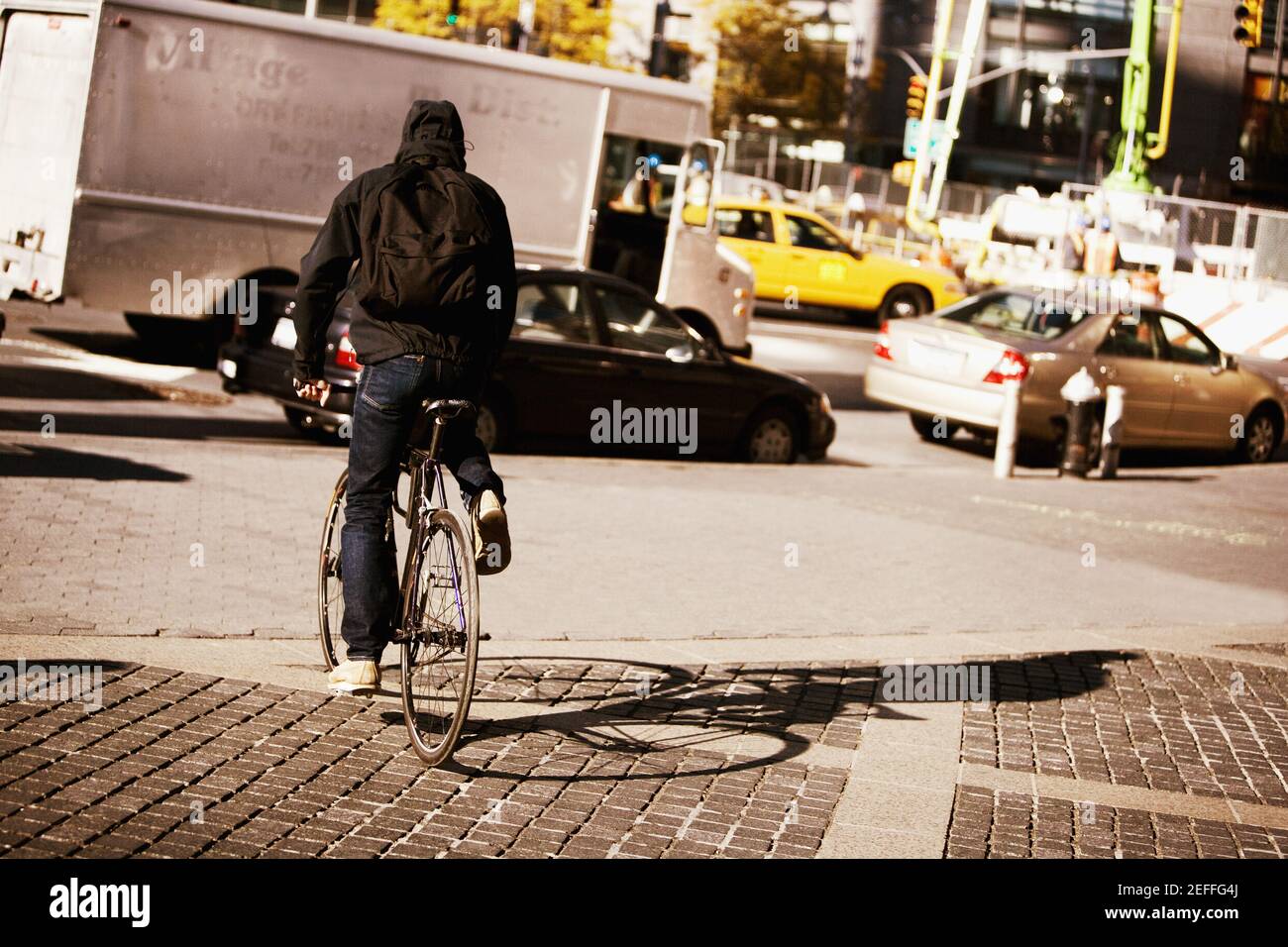 People cycling on cobblestone hi-res stock photography and images - Alamy