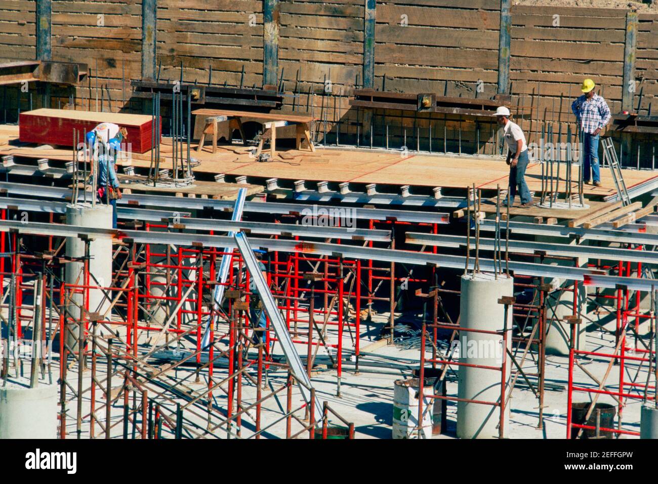 Construction workers at building site Stock Photo - Alamy