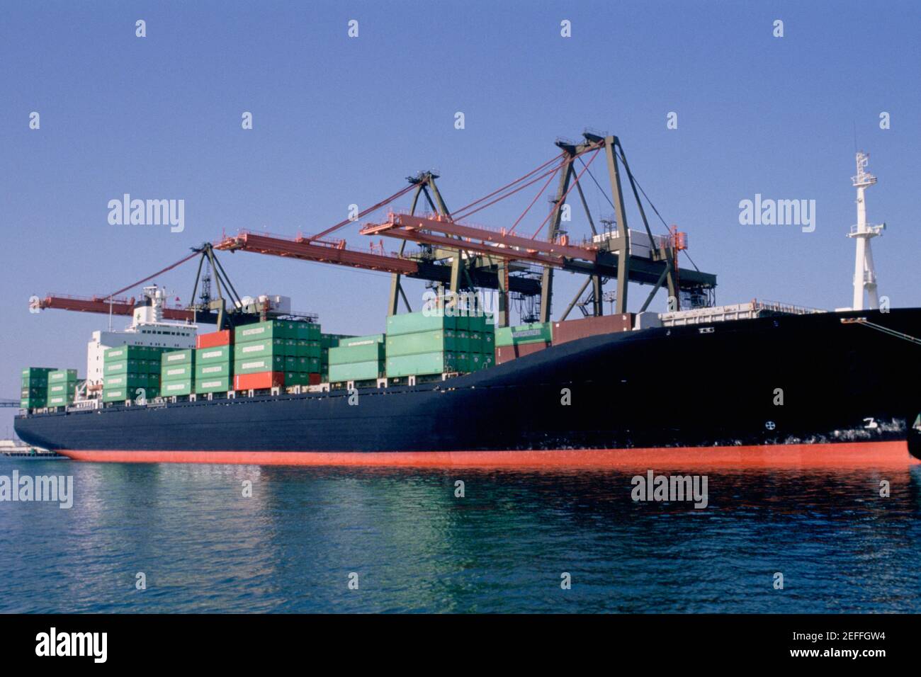 Container ship being loaded at the dock Stock Photo - Alamy