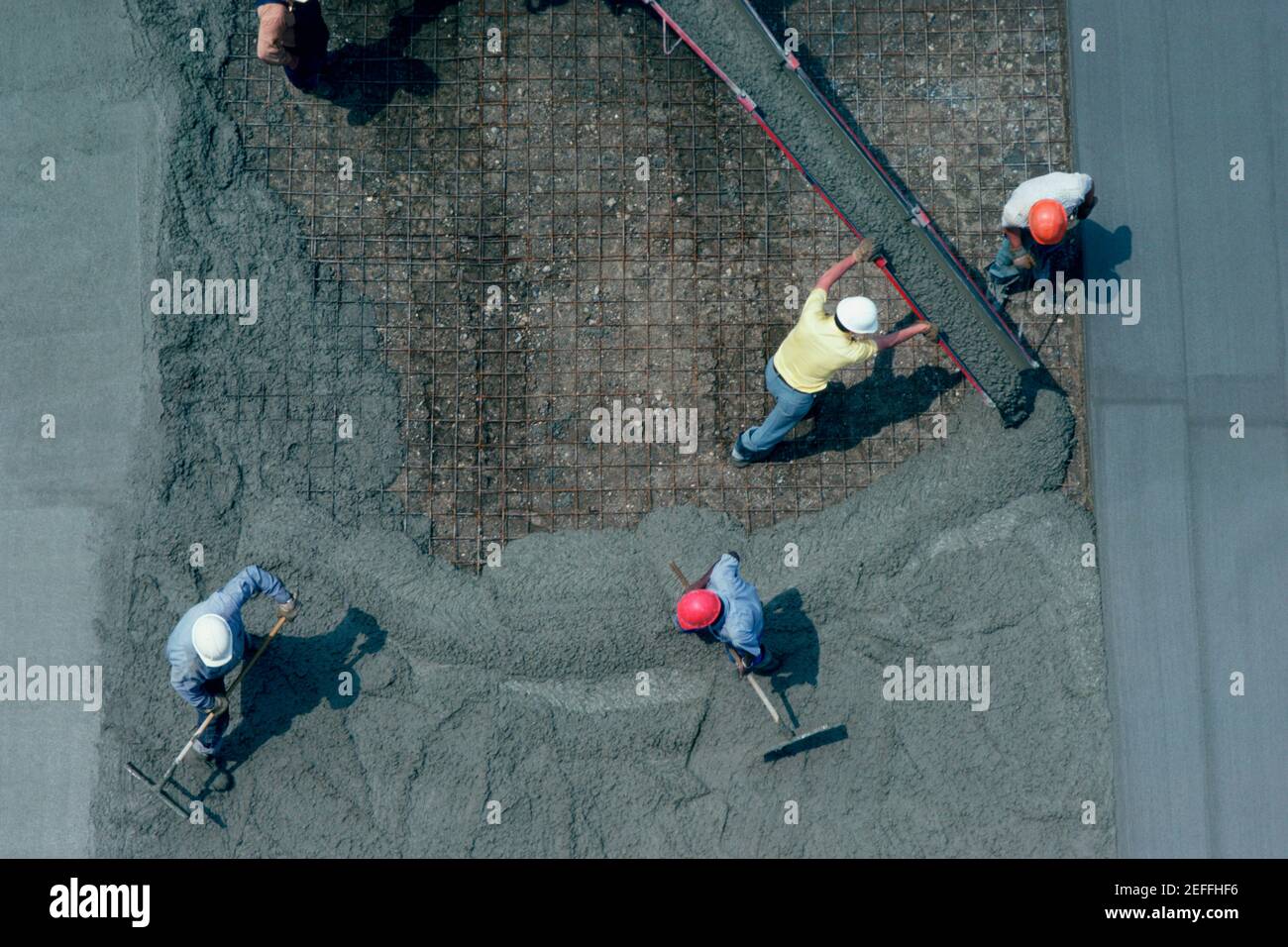 Laying cement for road construction Stock Photo - Alamy