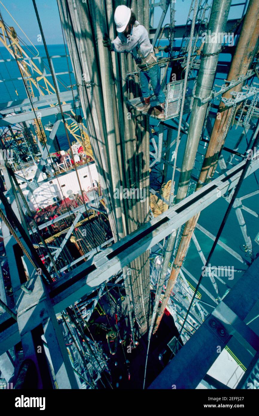 Worker on an oil derrick Stock Photo - Alamy