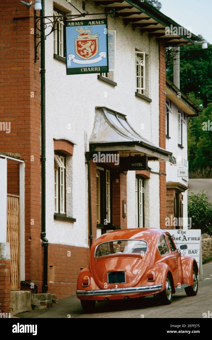 An orange car is parked outside a pub, England Stock Photo - Alamy