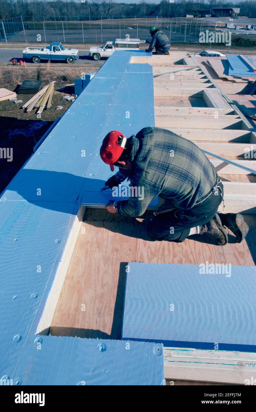 Putting insulation into solar-powered home, Maryland Stock Photo - Alamy