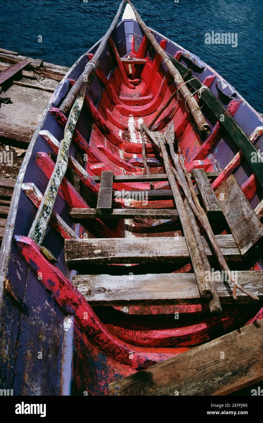 An old painted boat with an oar Stock Photo - Alamy