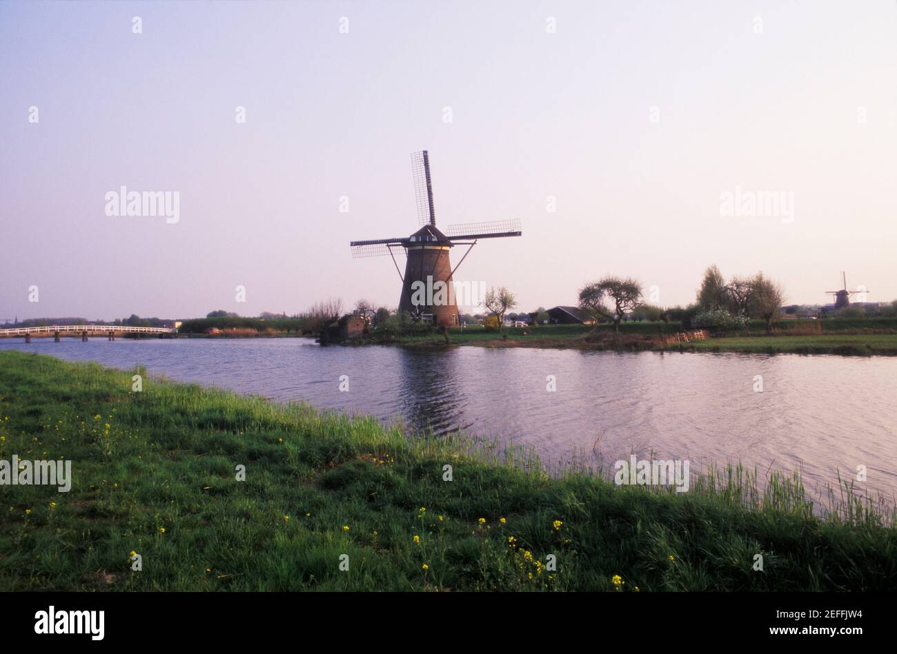 Traditional windmill near a pond, Amsterdam, Netherlands Stock Photo ...