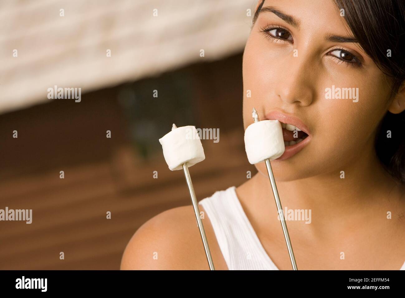 Portrait of a teenage girl eating marshmallows Stock Photo - Alamy