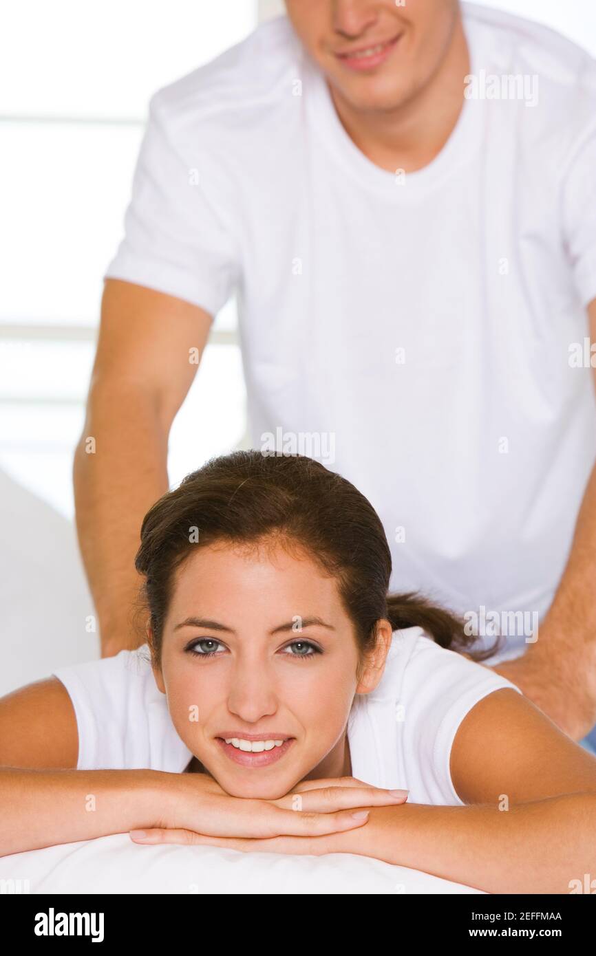 Portrait of a young woman getting a shoulder massage Stock Photo - Alamy