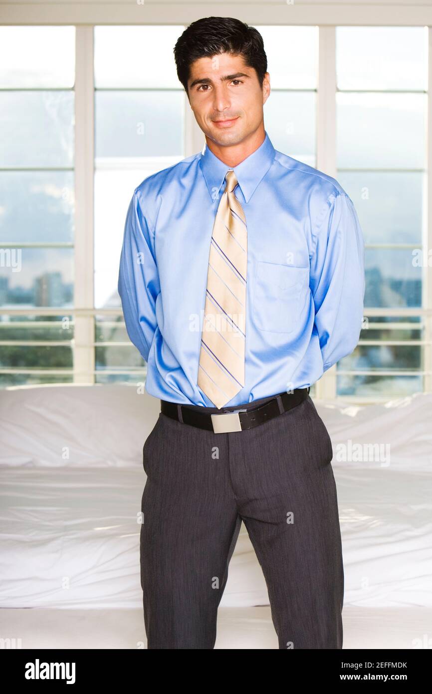 Portrait of a businessman standing with his hands behind his back Stock ...