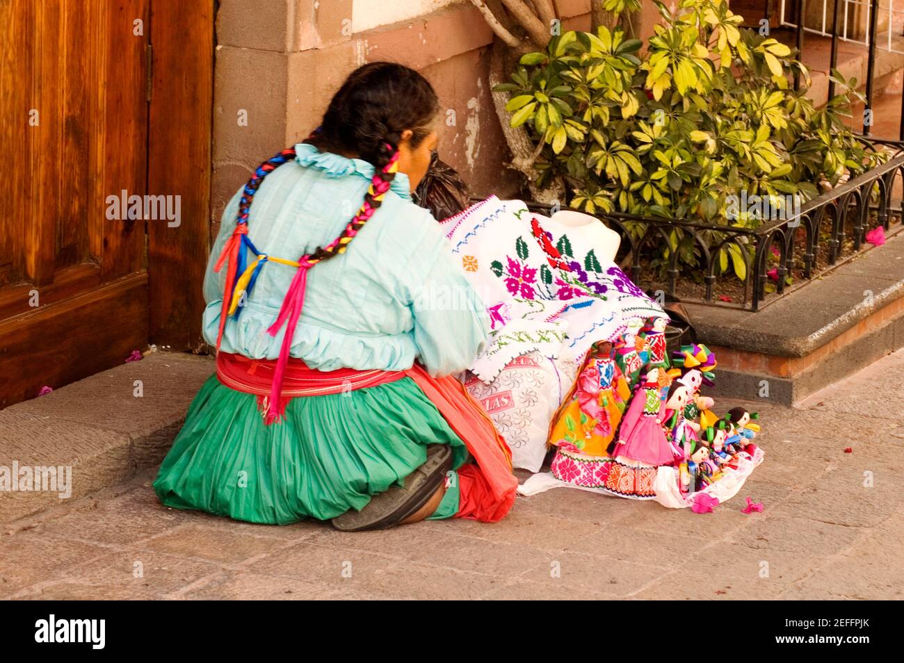 Rear view of a woman with puppets, Mexico Stock Photo - Alamy