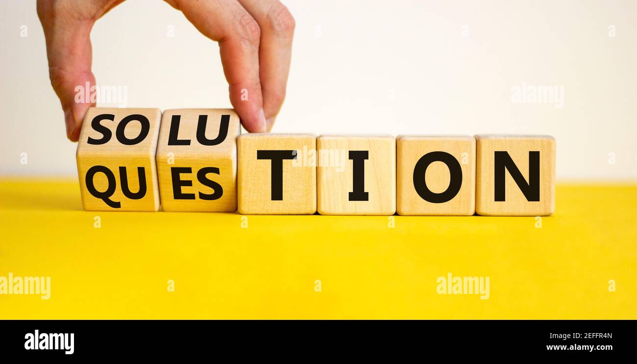 Question and solution symbol. Businessman turns wooden cubes and ...