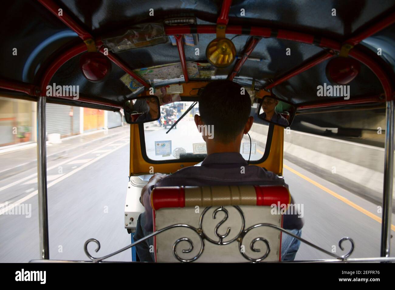 Rear view of a man driving a tuk-tuk, Bangkok, Thailand Stock Photo - Alamy