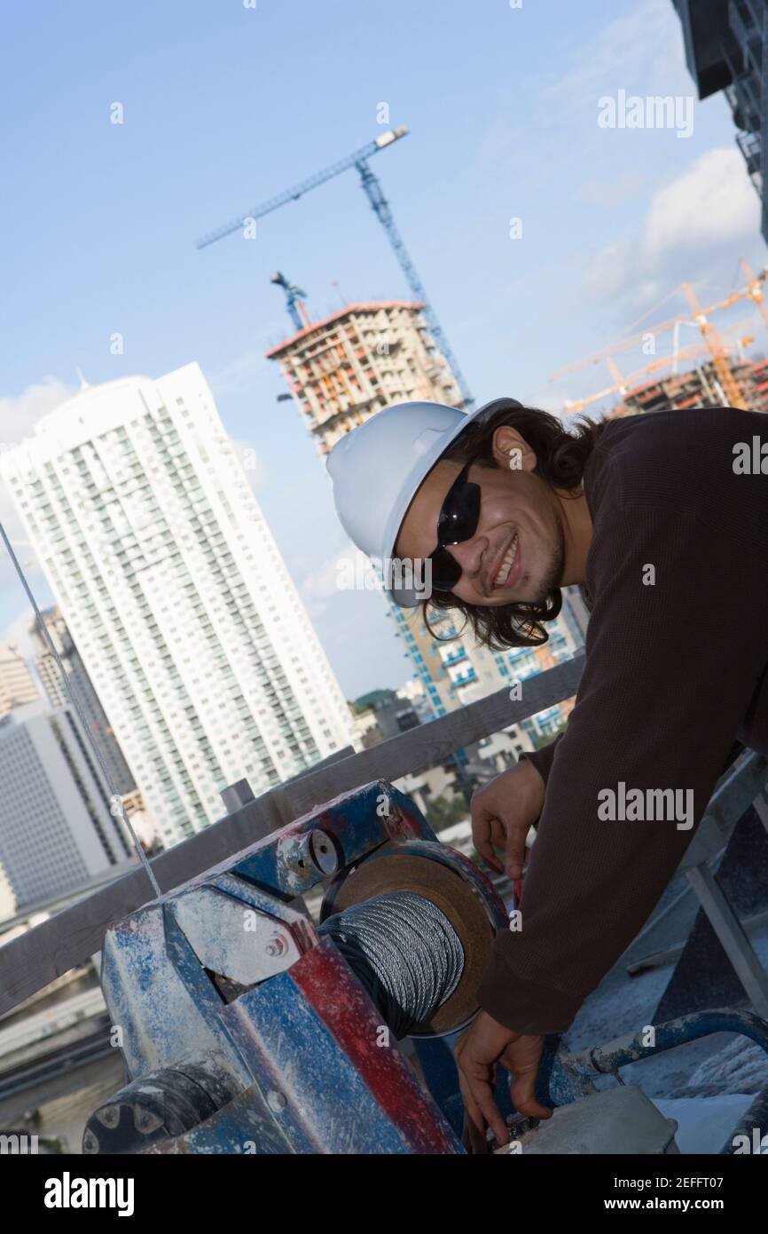 Side profile of a male construction worker working at a construction ...