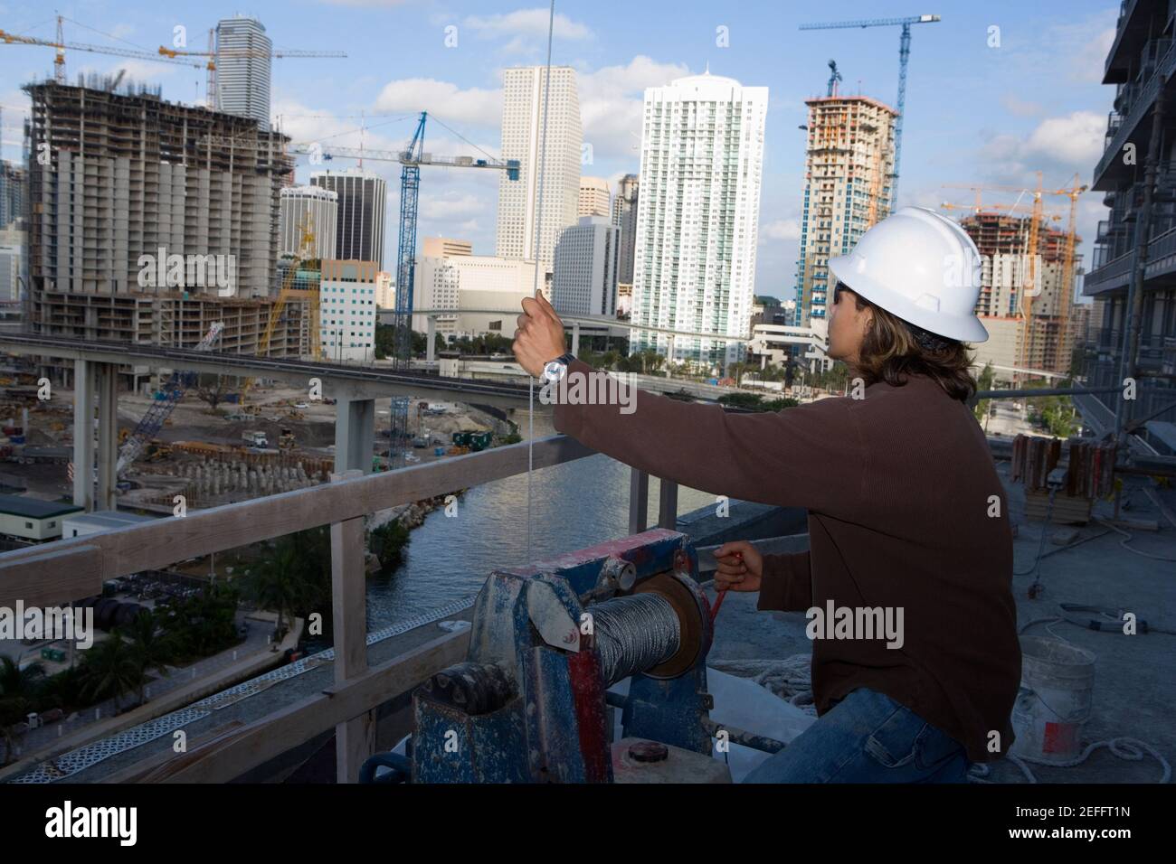 Side profile of a male construction worker working at a construction ...