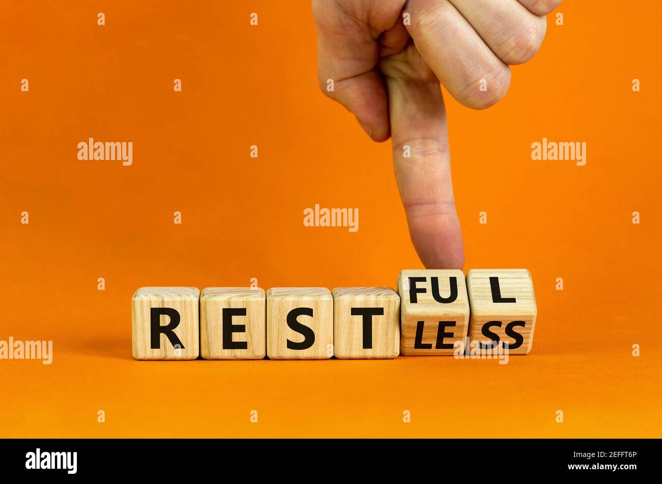 Restless or restful symbol. Businessman turns wooden cubes, changes the ...
